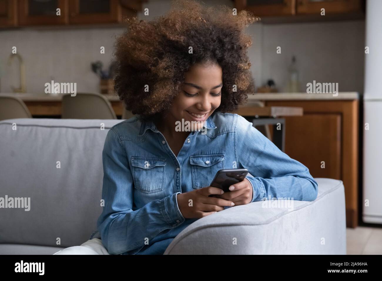 Cheerful beautiful gen Z teenage African girl using virtual app Stock ...