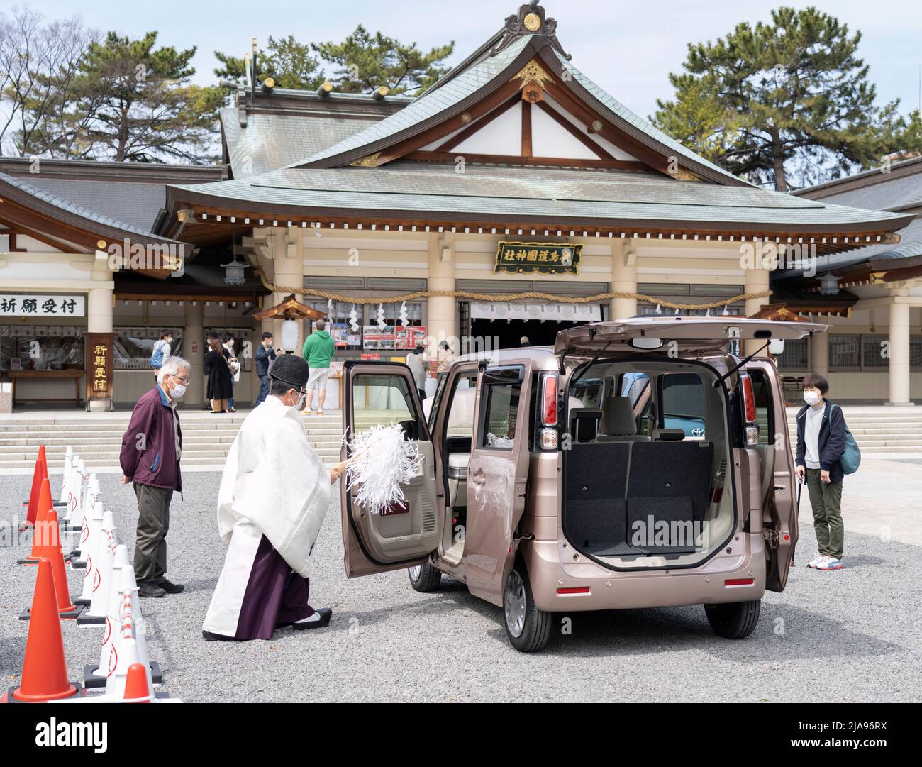 Shinto priest blessing a new car at Hiroshima Gokoku Shrine, Hiroshima ...