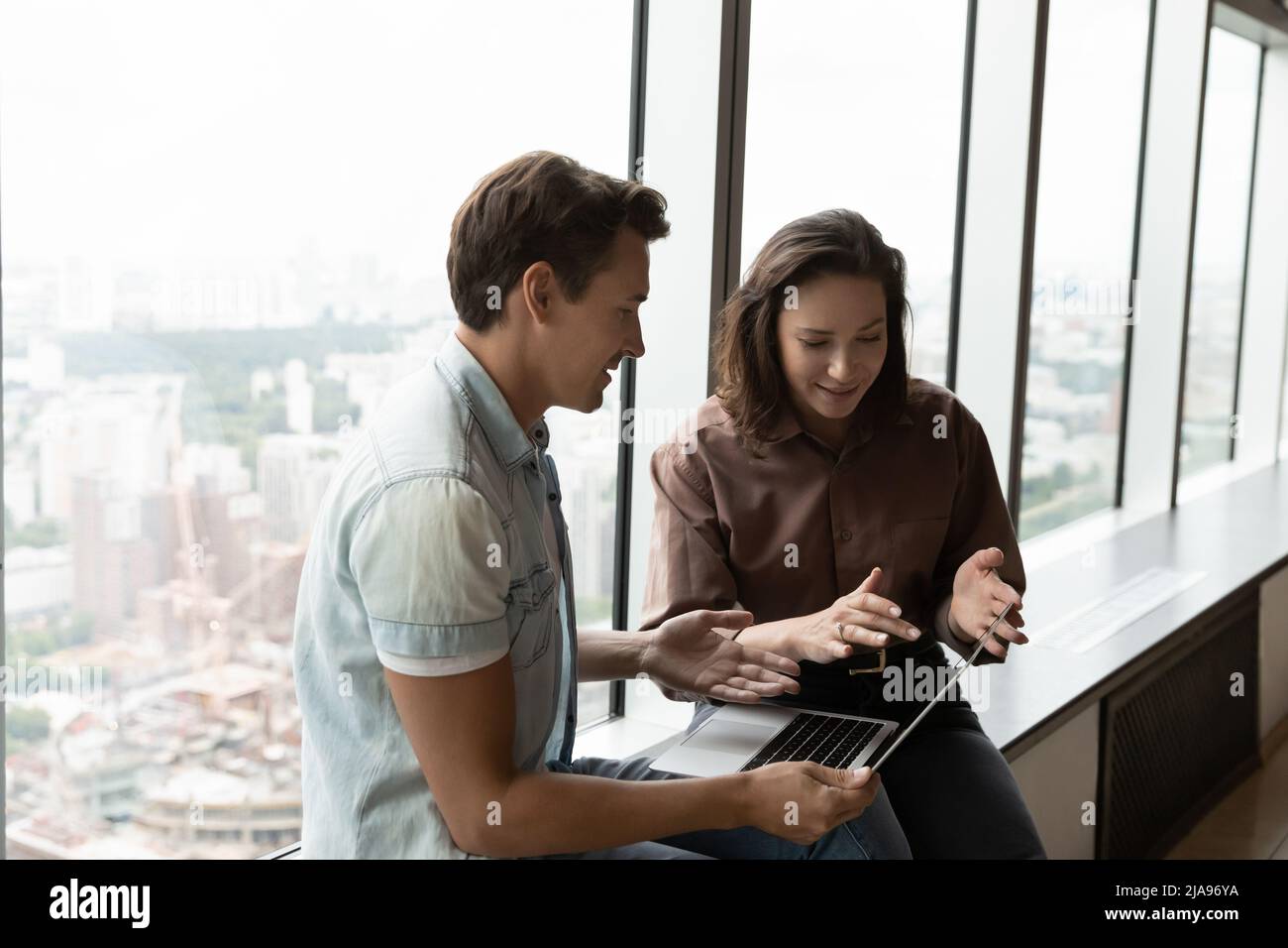 Engaged office coworkers discussing work project at brief meeting Stock ...