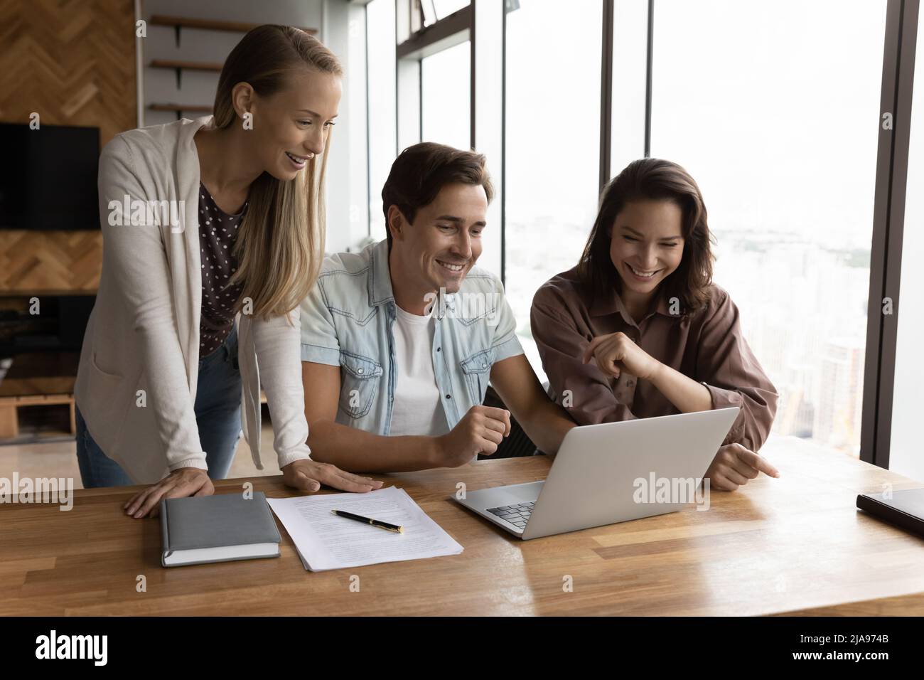 Happy business team watching online training or virtual presentation ...