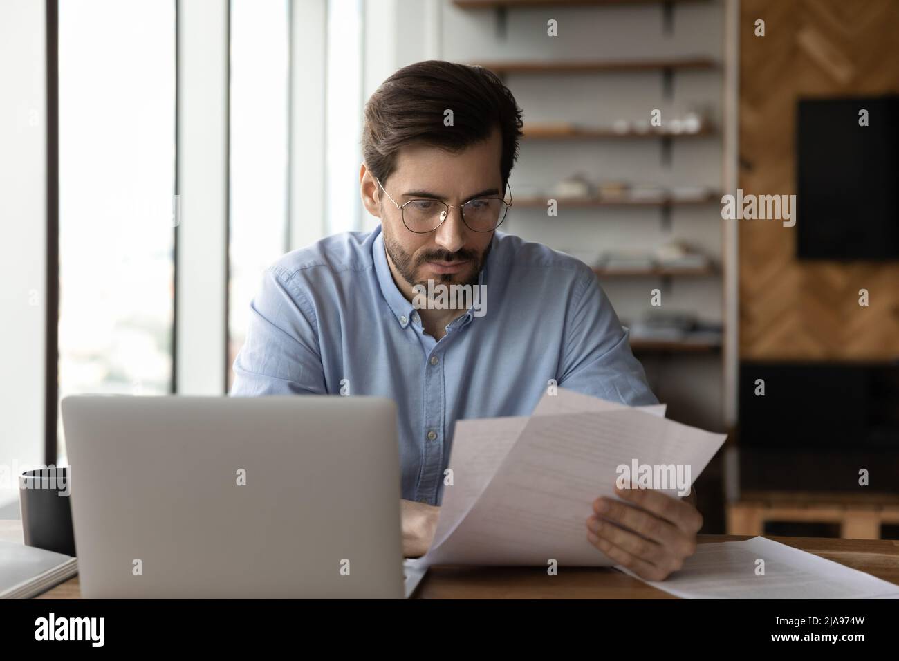 Focused businessman reviewing paper reports, received letter Stock ...
