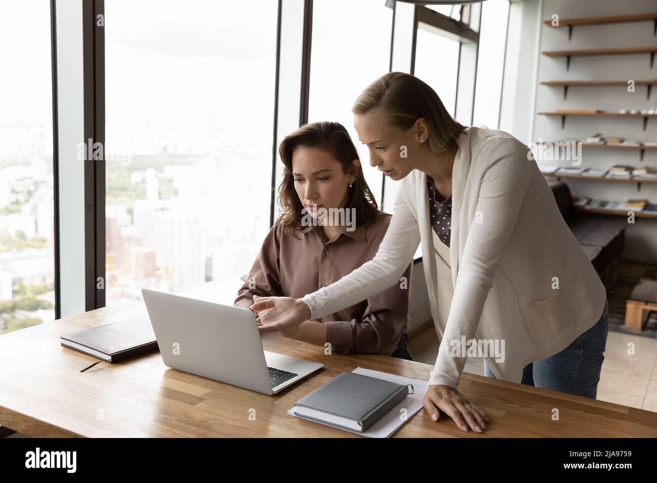 Corporate business teacher supervising work of new employee Stock Photo ...