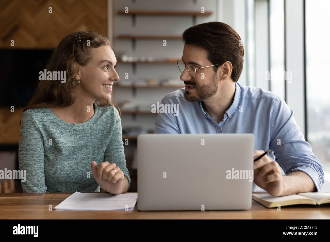 Business mentor and happy intern discussing training task at workplace ...