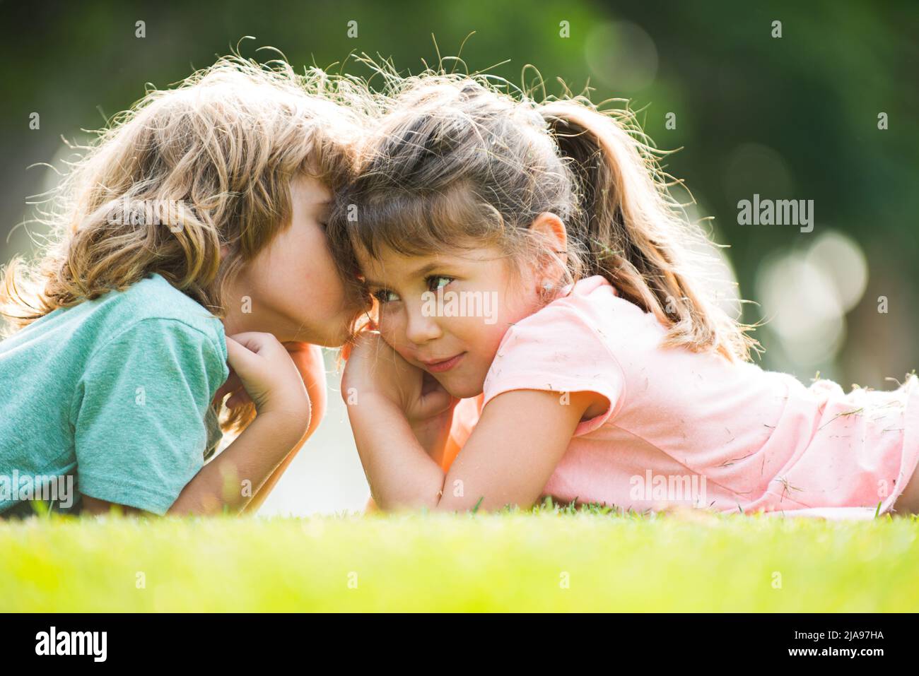 Hugging and kissing kids couple. Little lovely children outdoor ...