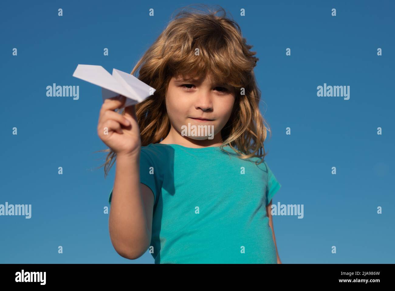 Paper airplane in children hands, child throwing a paper airplane into ...