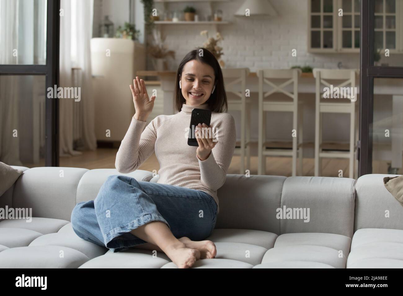 Cheerful happy young millennial woman excited with video call talk ...