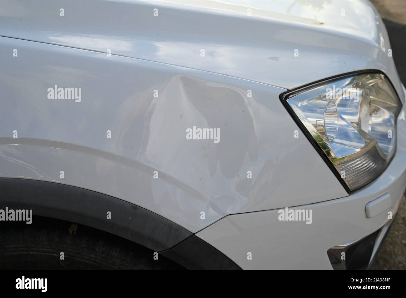 The dented vandalised front wing of a car Stock Photo - Alamy