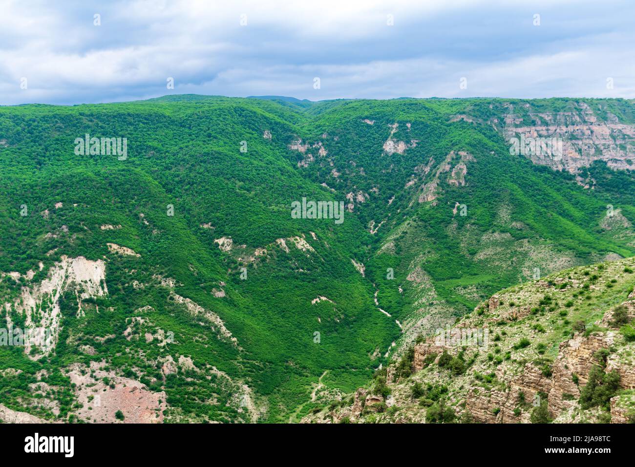 mountain landscape, view of a huge gorge with rocky green slopes Stock ...