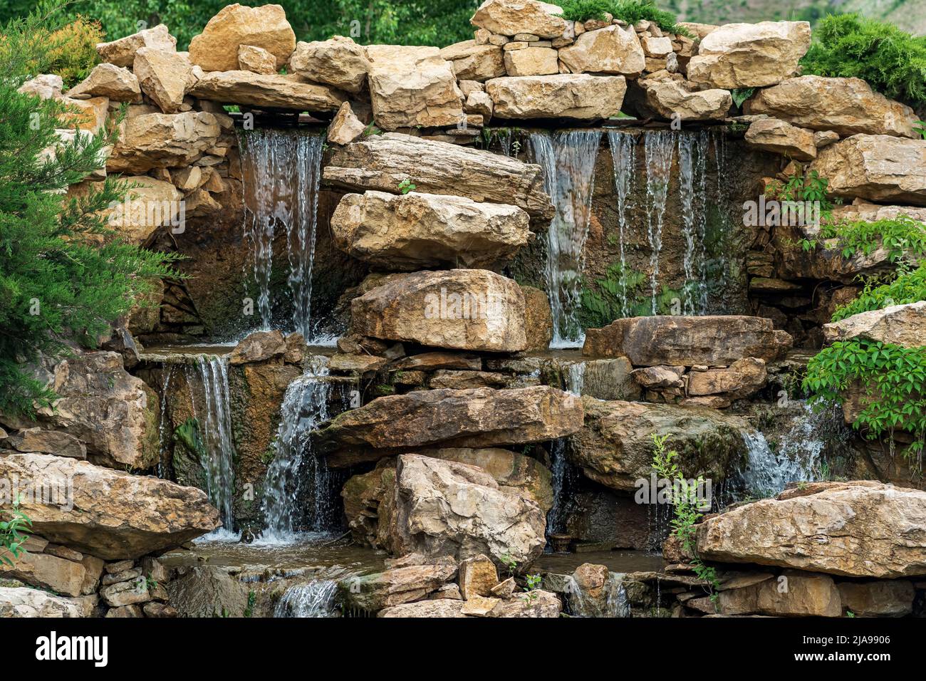 landscape design, a dam with a cascade of waterfalls in the form of ...