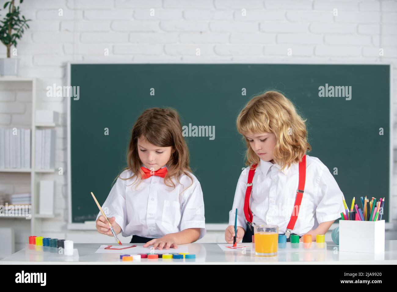 Portrait school kids doing art homework. Children drawing on elementary ...