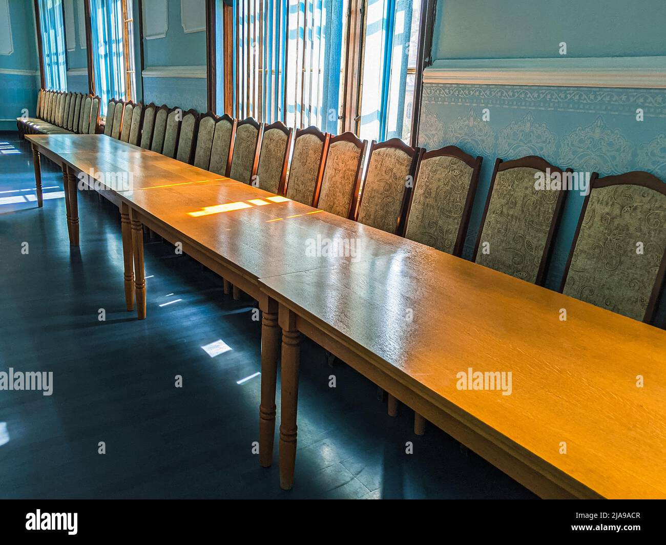 classic chairs and table stand in a row, room interior Stock Photo - Alamy
