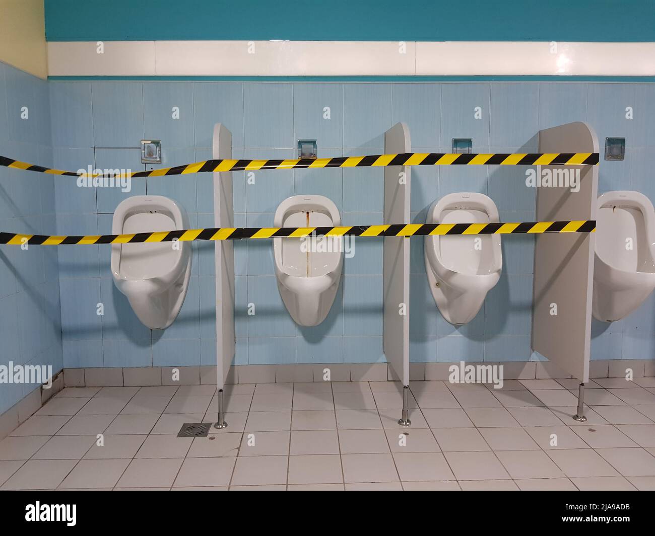 Closed men's room with white public toilets porcelain urinals with ...