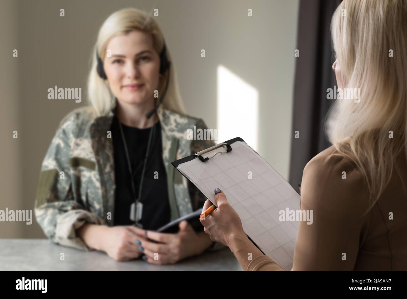 Psychologist making notes during therapy session with soldier, PTSD ...
