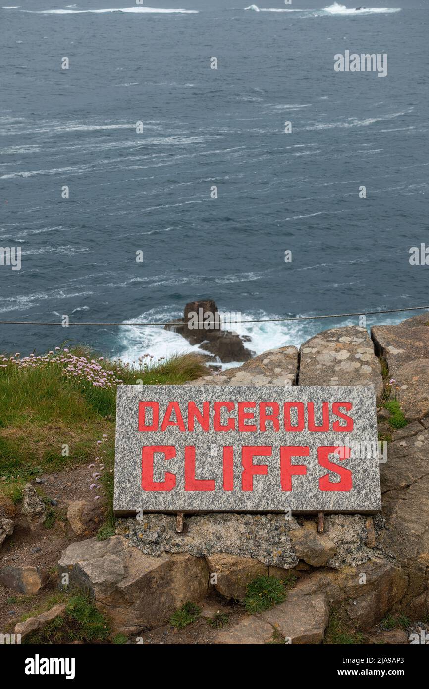 Dangerous cliffs sign in red writing and a flat marble slab Stock Photo ...
