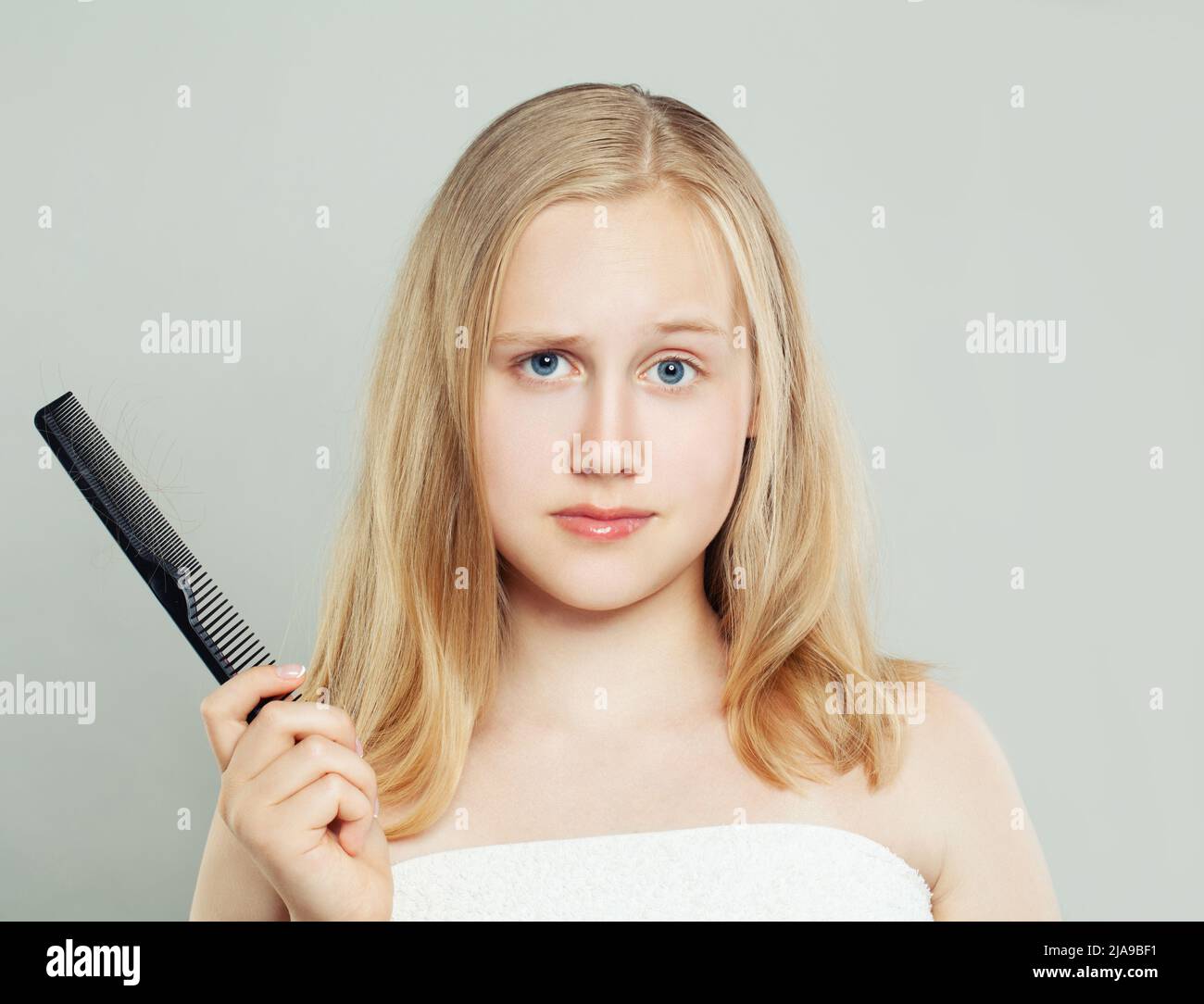 Cute sad teen girl showing comb with hair. Hair loss concept Stock ...