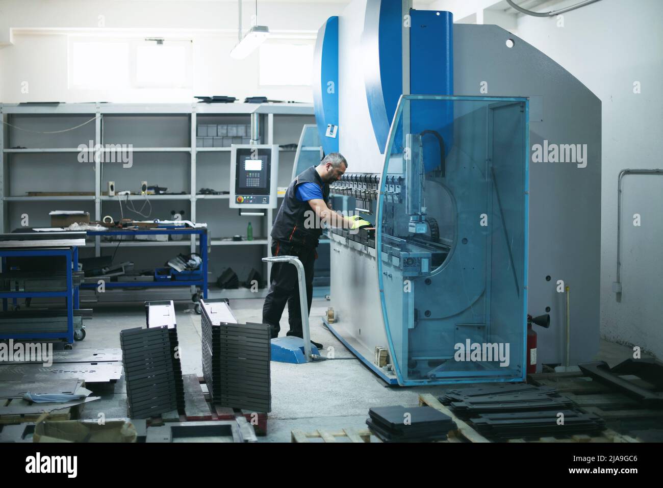 A smart factory worker or engineer makes machines in a production ...