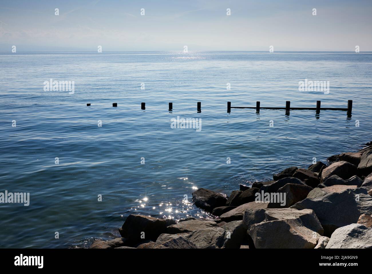 Rock armour bloulders sea defences and timber beach groyne partly ...