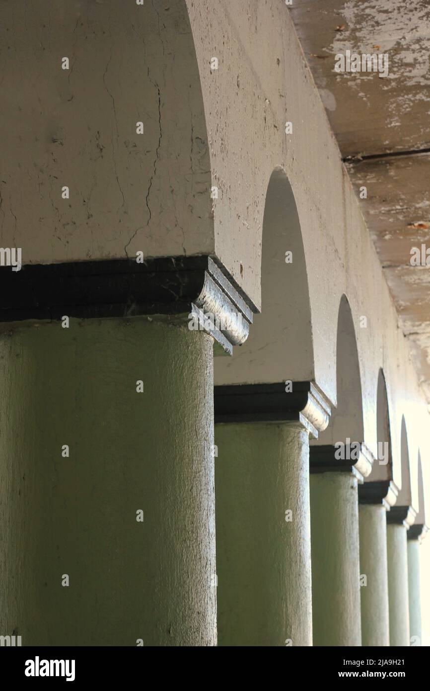 Industrial inner city colonnade of concrete columns holding up a bridge ...