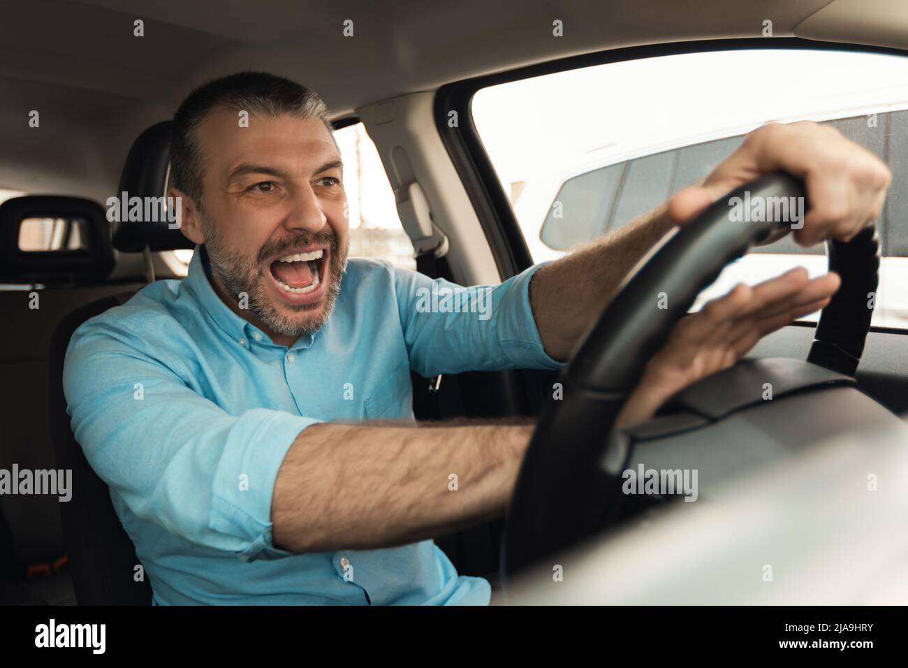 Angry man driving car shouting and honking Stock Photo - Alamy