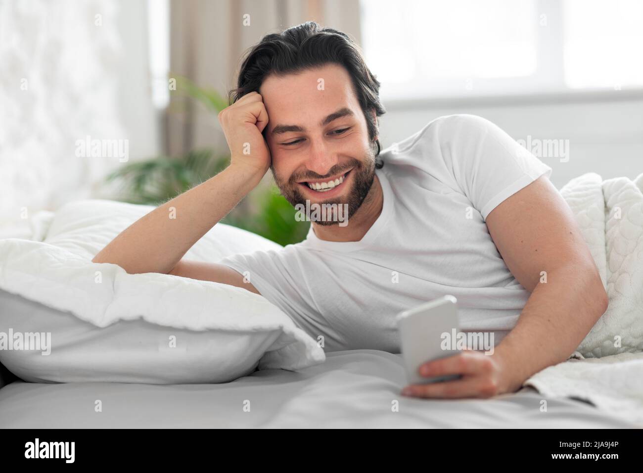 Happy millennial man using hi-res stock photography and images - Alamy