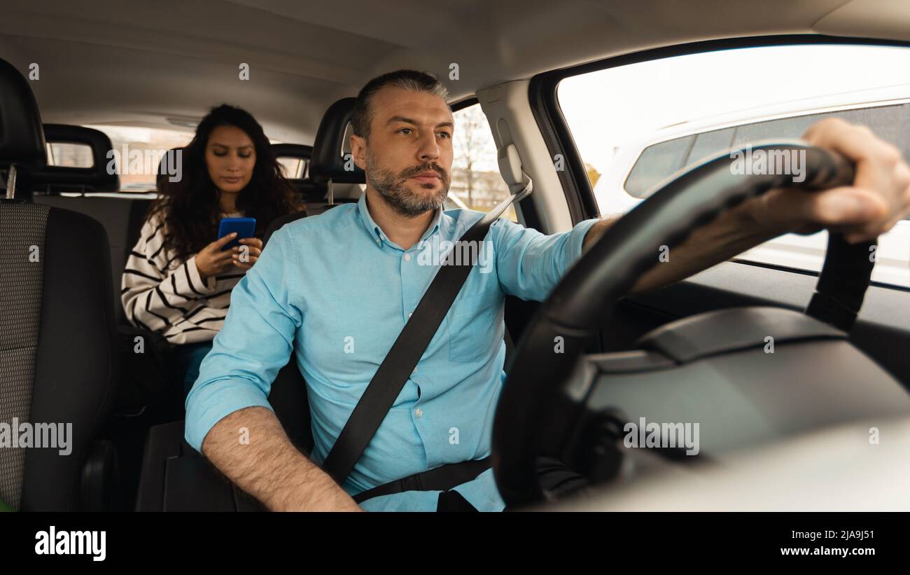 Portrait of male driver riding car with passenger Stock Photo - Alamy