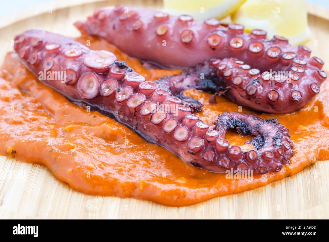 Roasted octopus tentacles with chilli romesco sauce Stock Photo - Alamy