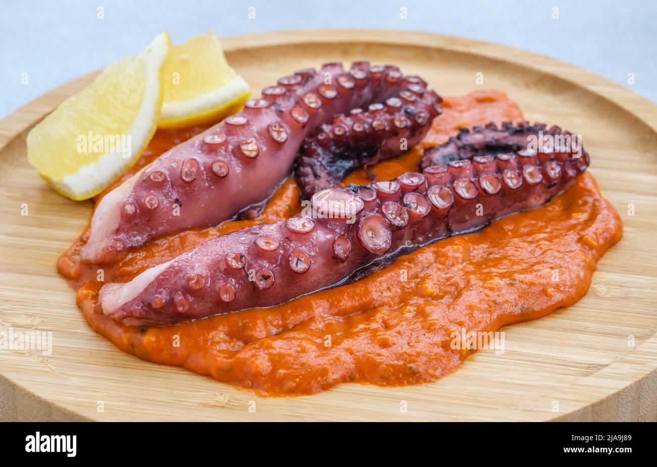 Roasted octopus tentacles with chilli romesco sauce Stock Photo - Alamy