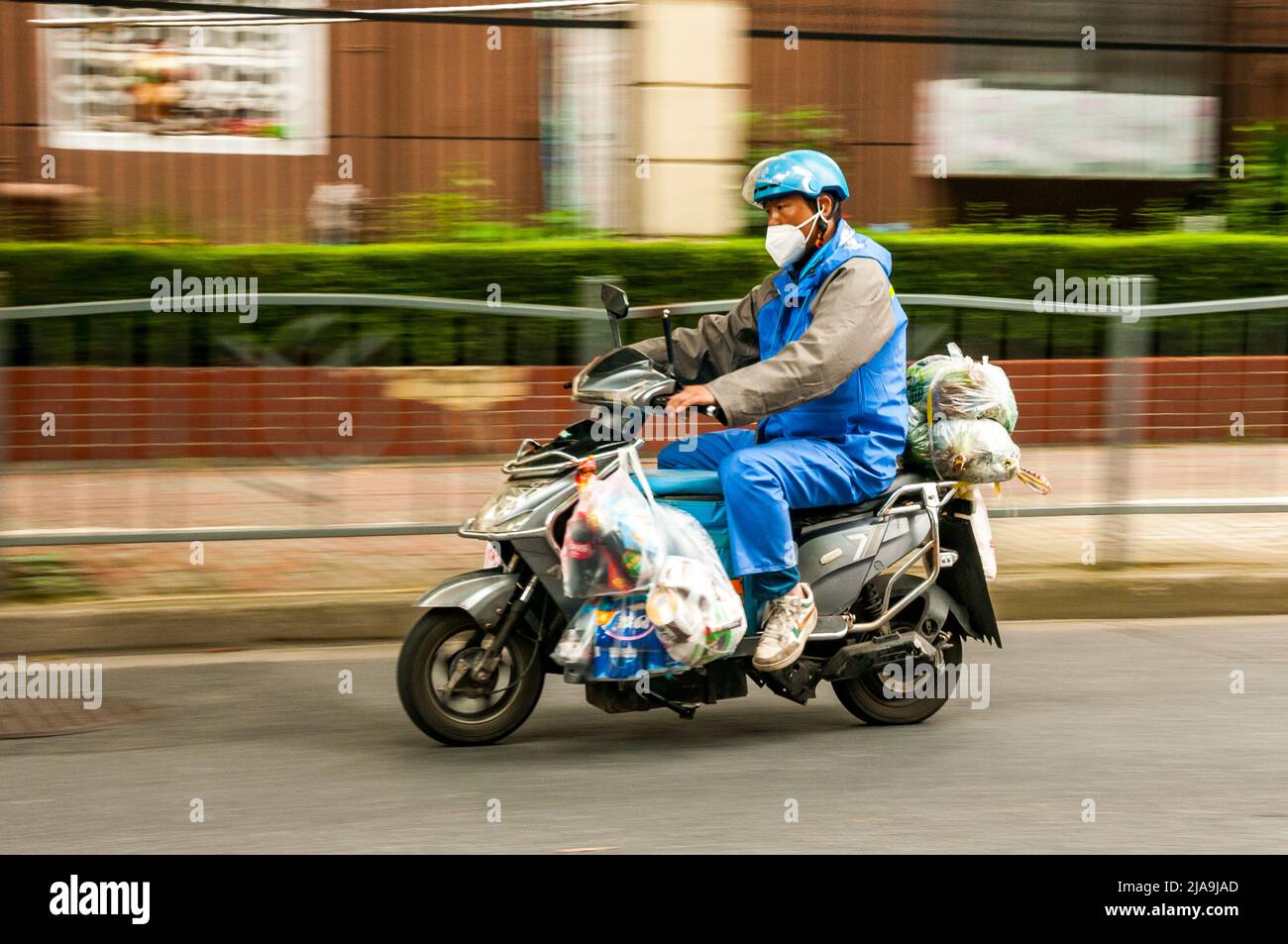 A delivery rider delivering groceries in Putuo District, Shanghai ...
