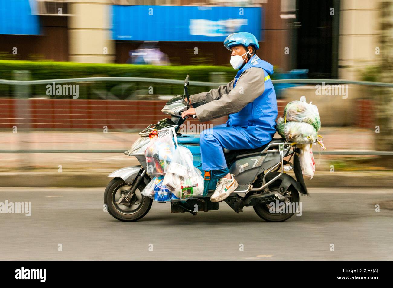 A delivery rider delivering groceries in Putuo District, Shanghai ...