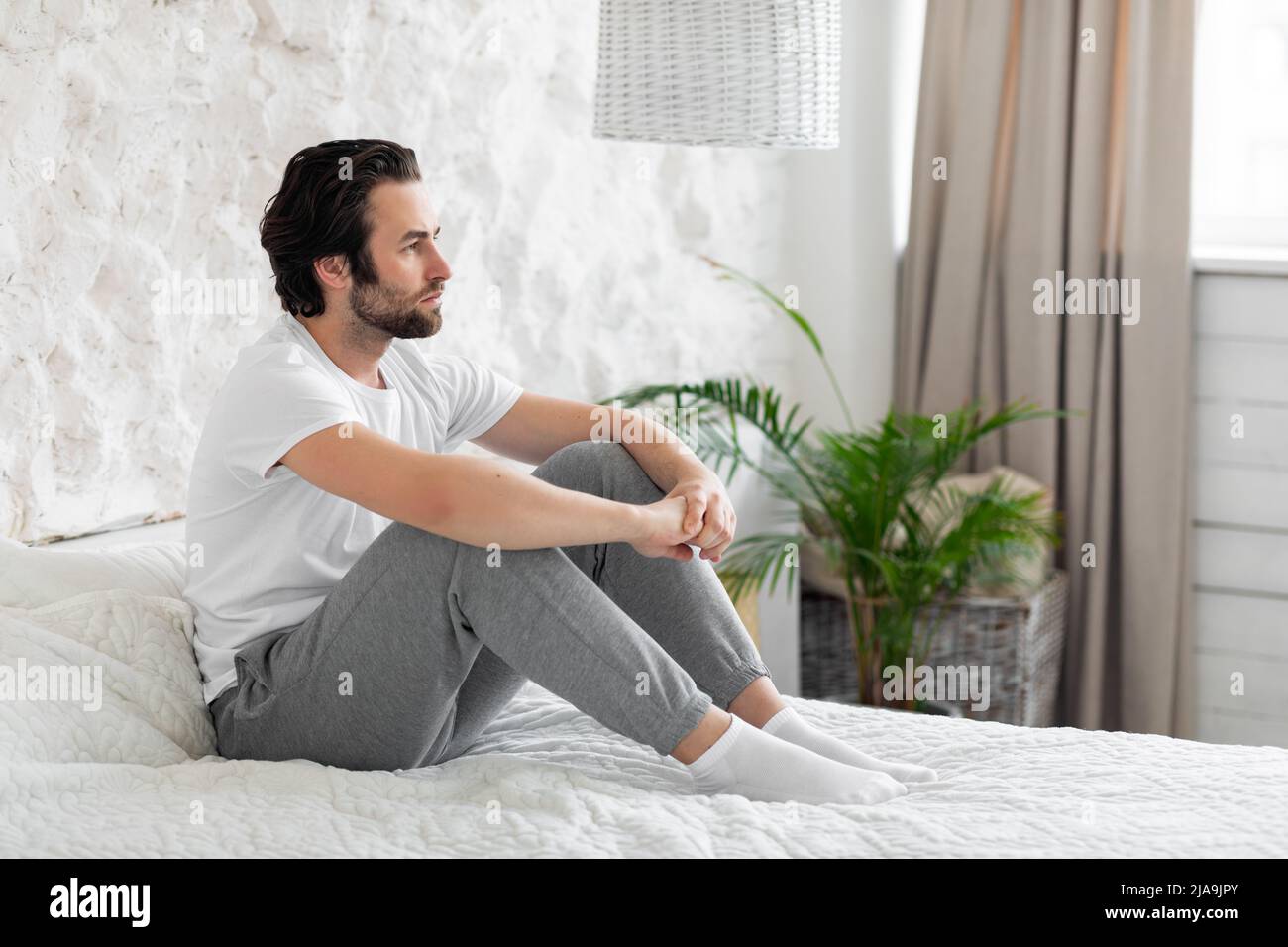 Lonely young man sitting on hi-res stock photography and images - Alamy