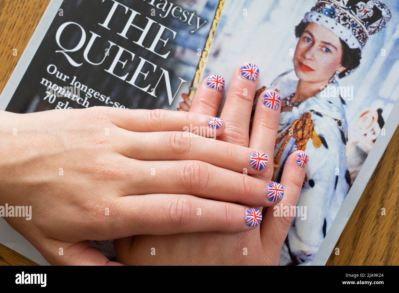 Woman with fingernails painted with the British flag resting on OK ...
