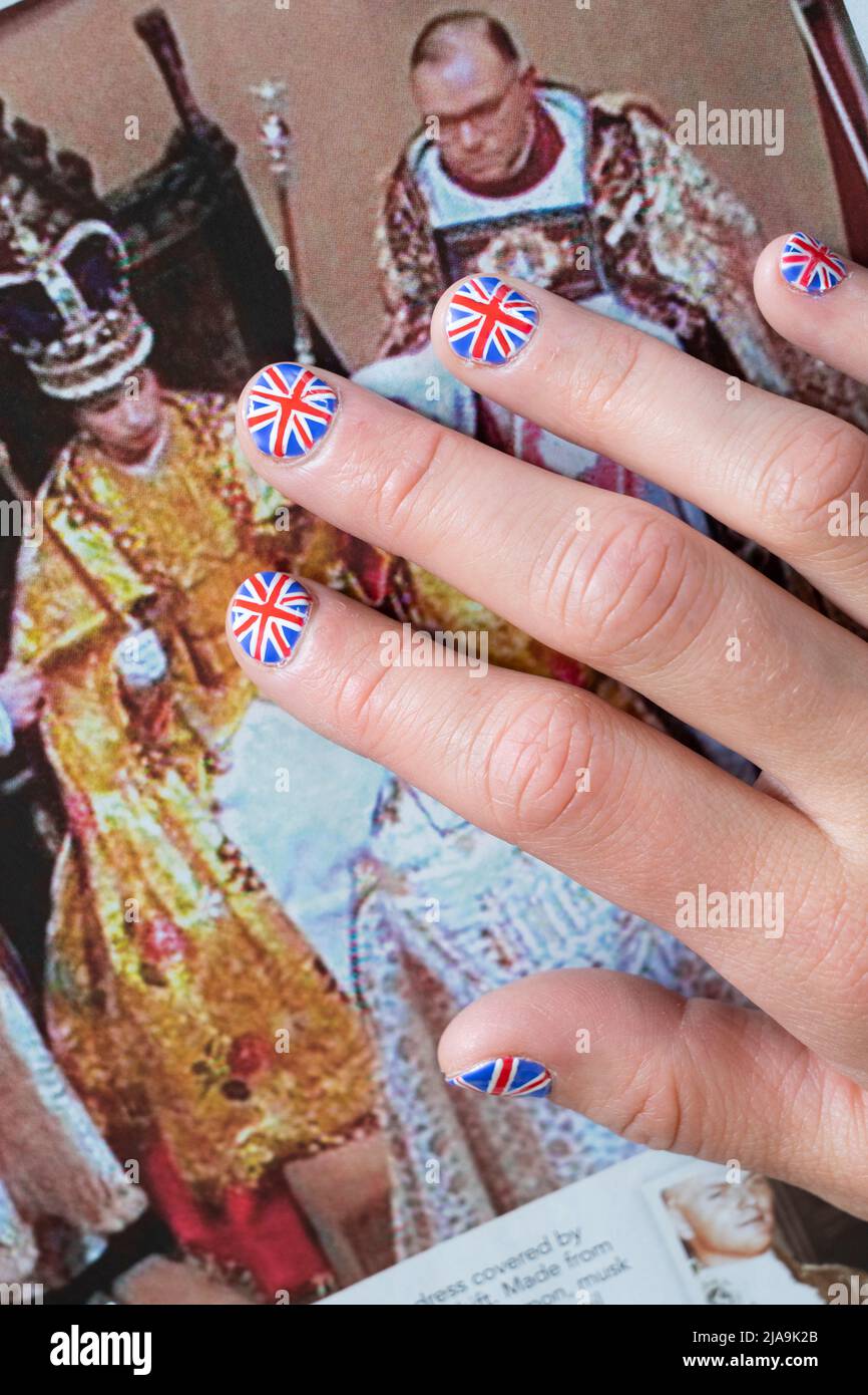 Woman with fingernails painted with the British flag resting on OK ...