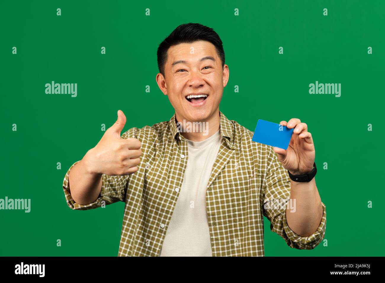 Happy mature asian man holding credit card and showing thumb up, male ...