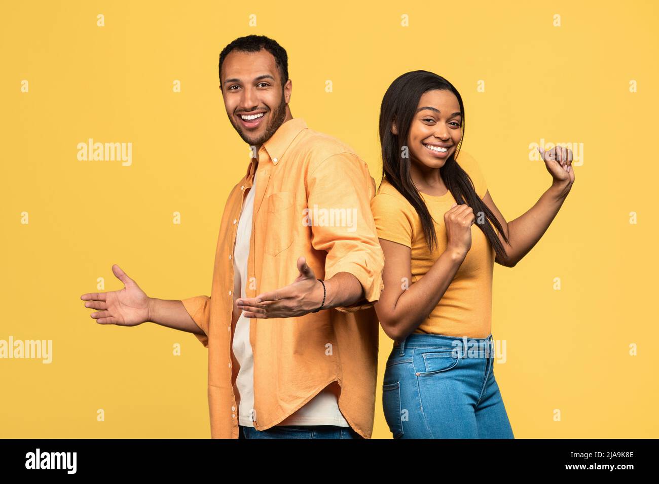 Cheerful young black couple dancing, celebrating success together on ...