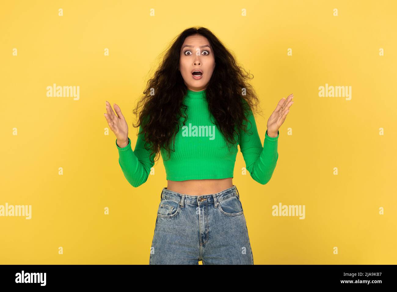 Excited woman with open mouth spreading hands Stock Photo - Alamy