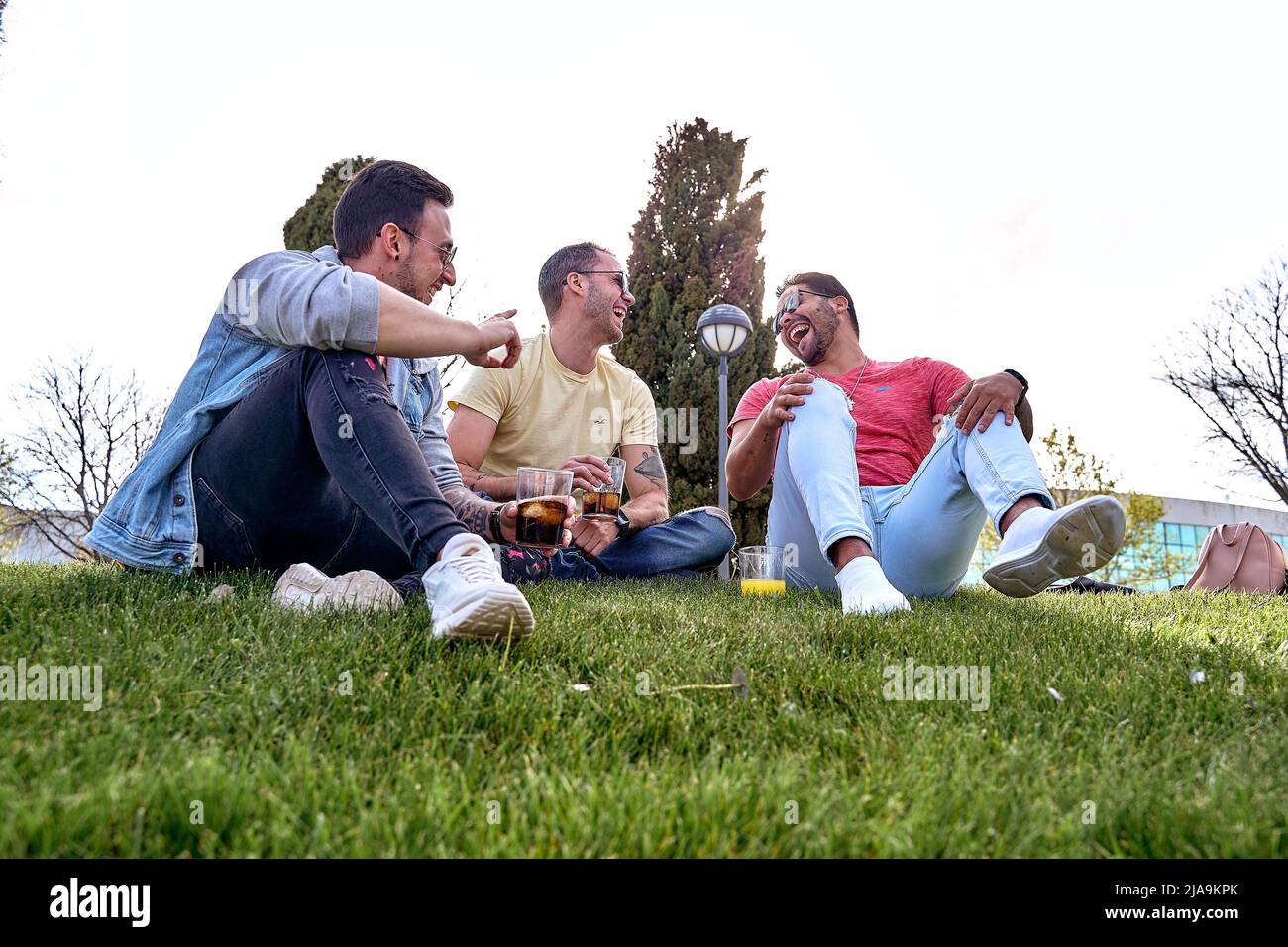 Group of friends drinking refreshing drinks while relaxing together ...