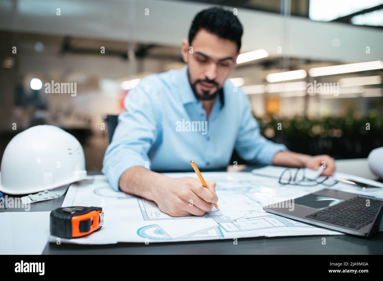 Concentrated serious attractive millennial arab man engineer with beard ...