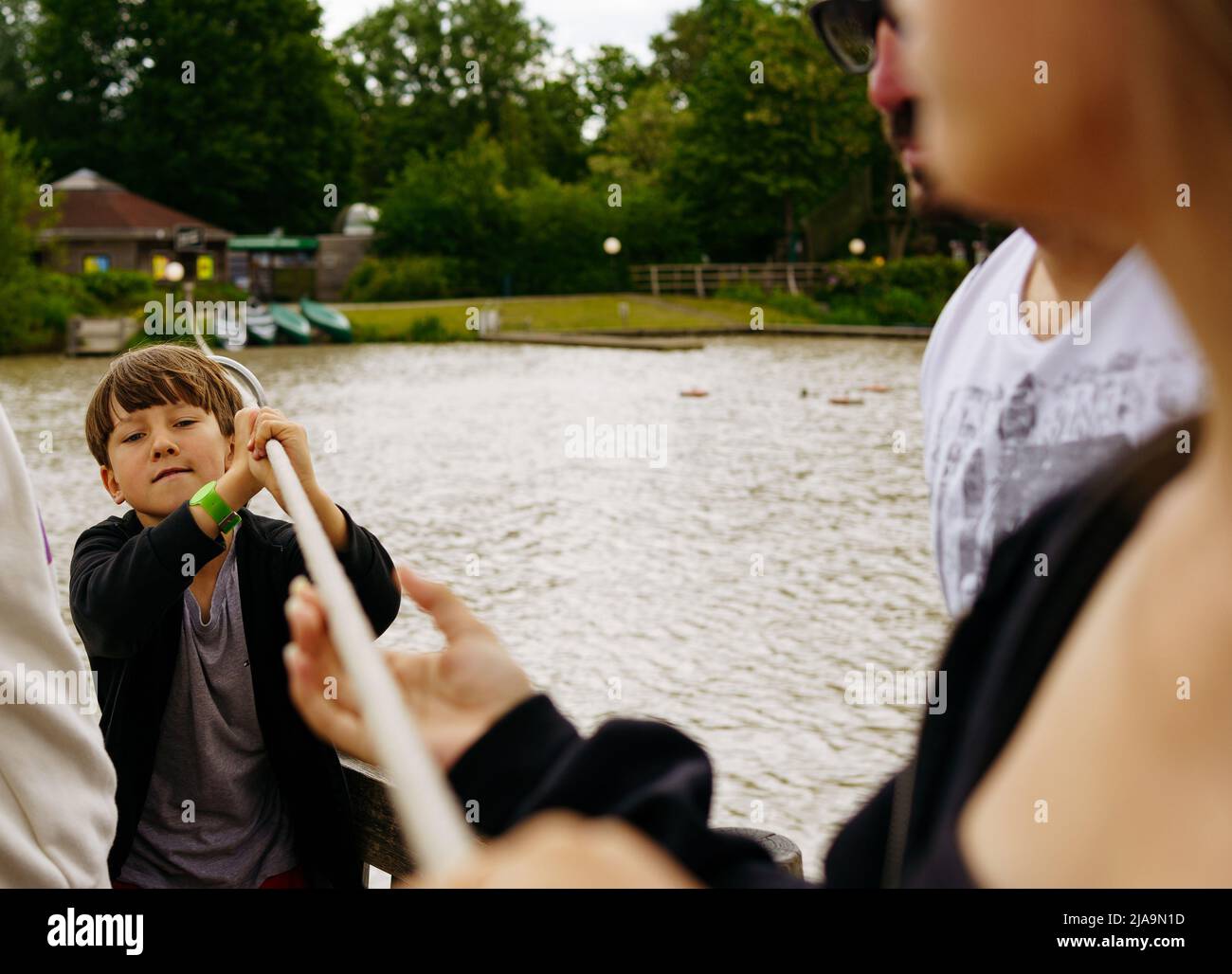 Boy pulling a raft with a rope across the lake Stock Photo - Alamy