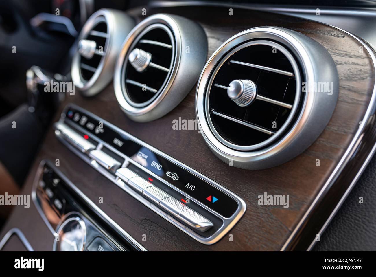 The interior of a modern passenger car with three vents visible and air ...