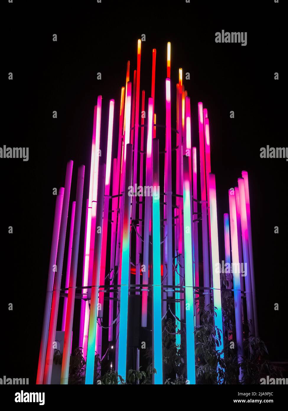 A bright multi-colored luminous installation illuminates the park at ...