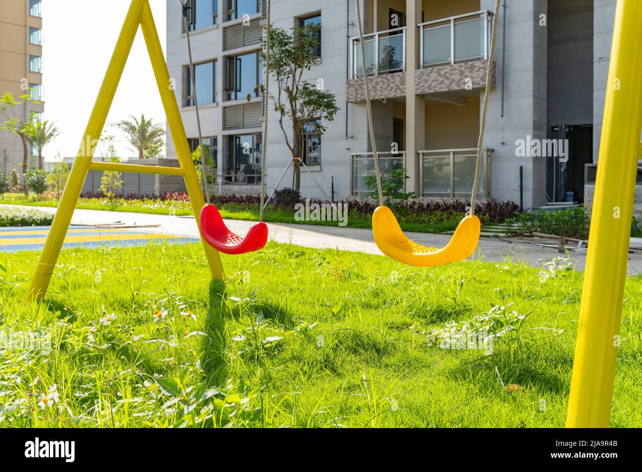 Swing playground in morning sunlight hi-res stock photography and ...