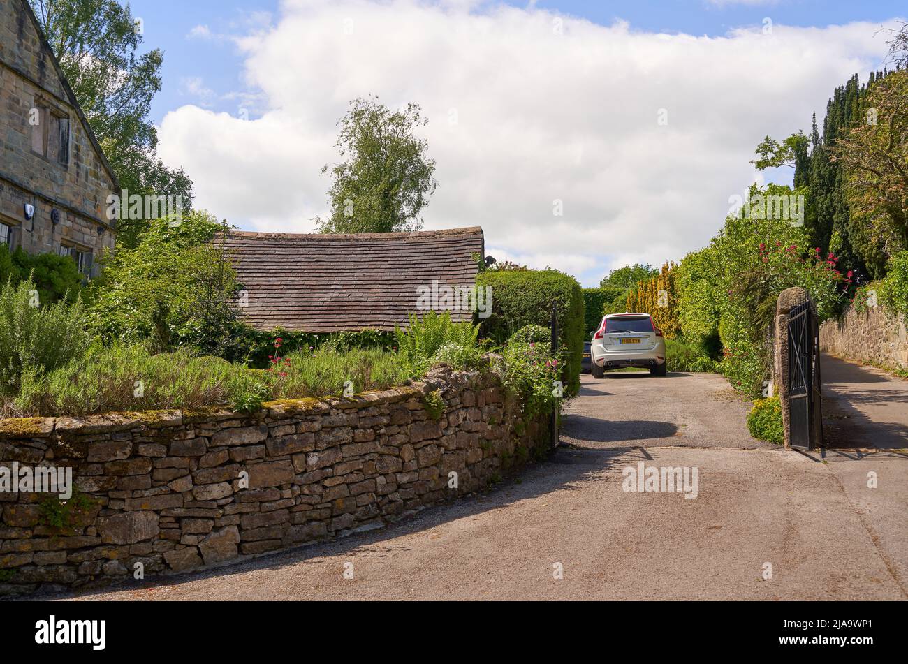 Private drive way in a village Stock Photo - Alamy