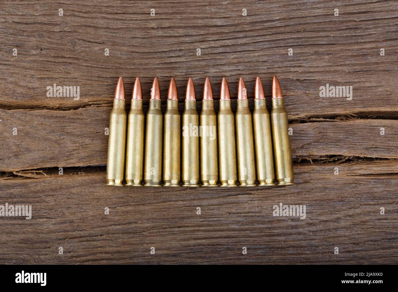 Rifle bullets on vintage wood table. Top view, close-up Stock Photo - Alamy