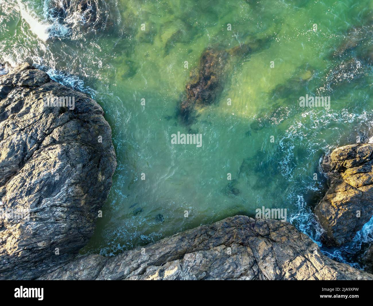 Downward aerial view of beach and crystal clear water Stock Photo - Alamy