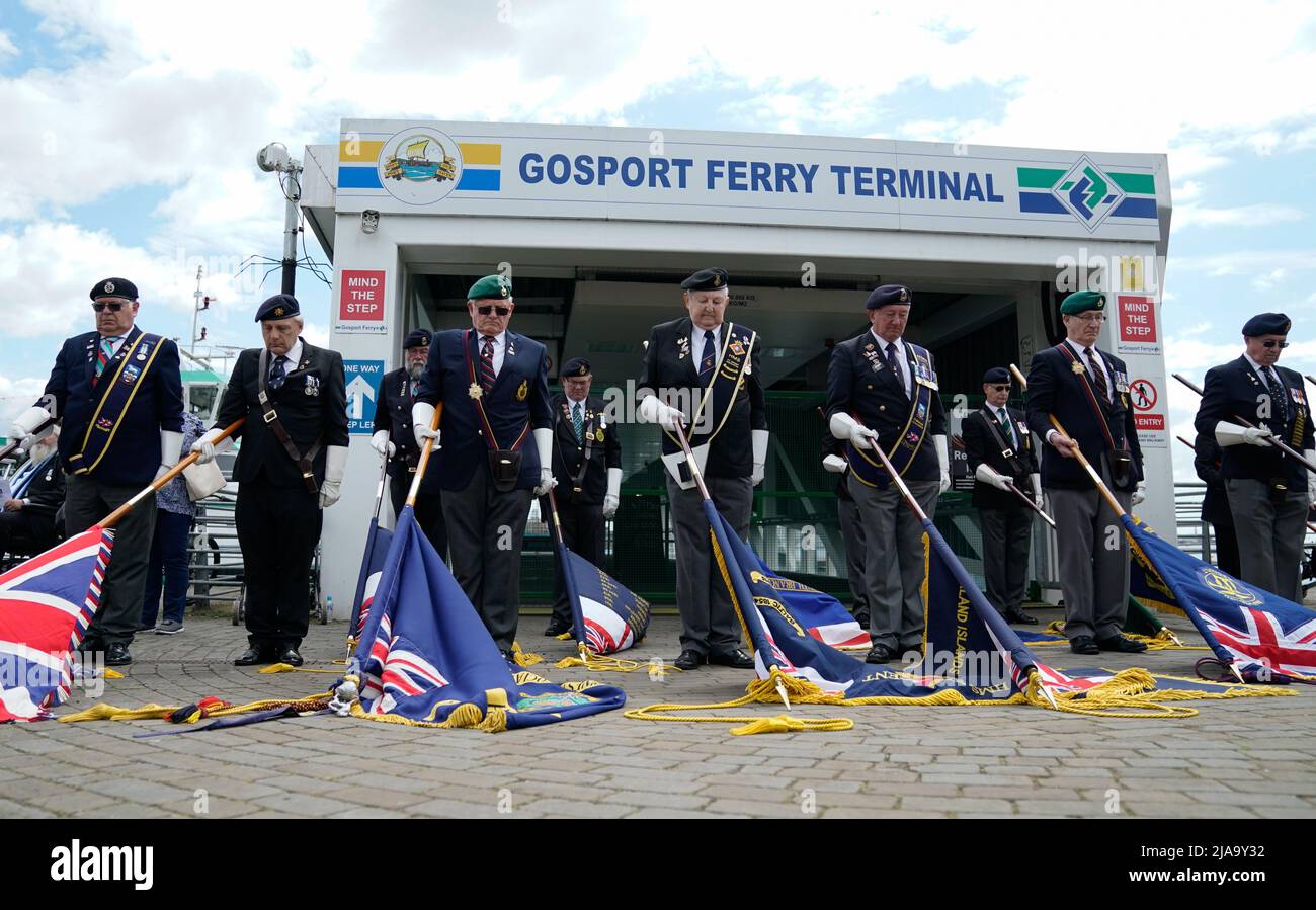 Standard bearers from the Royal British Legion lower their standards ...