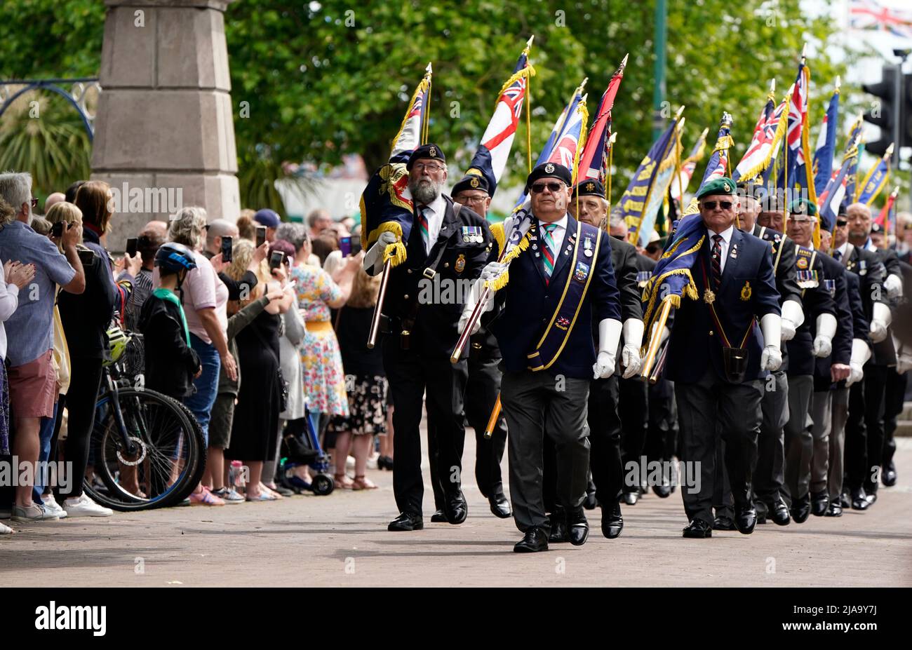 Standard bearers from the Royal British Legion march through the town ...