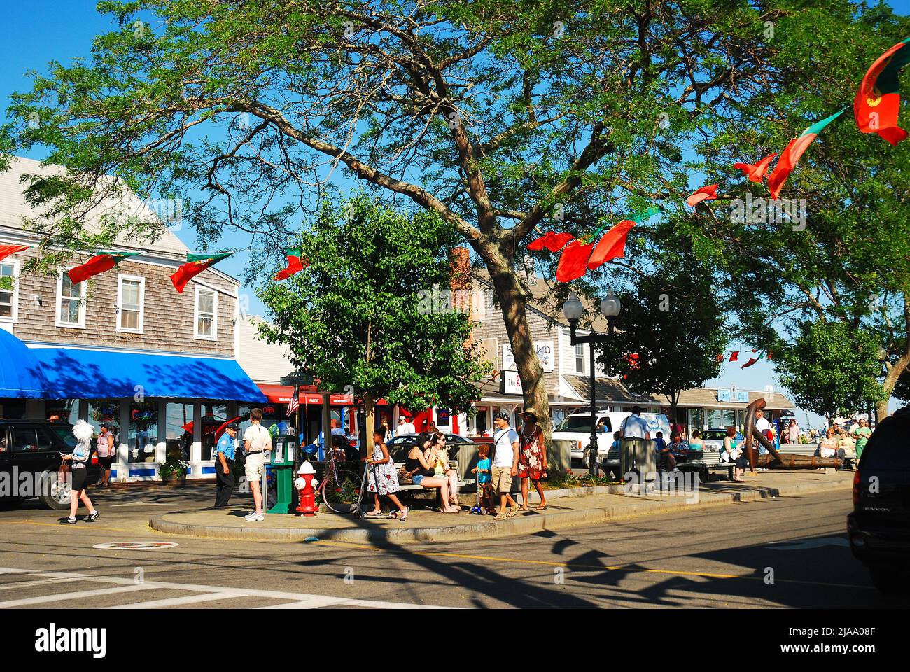 People enjoy a sunny summer’s day walking the quaint streets of ...