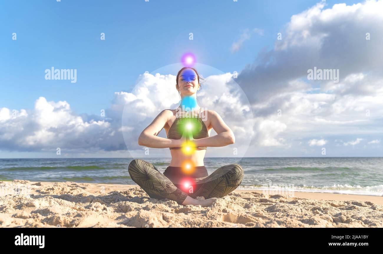 Seven chakras and aura. Slim woman meditating in lotus position in ...