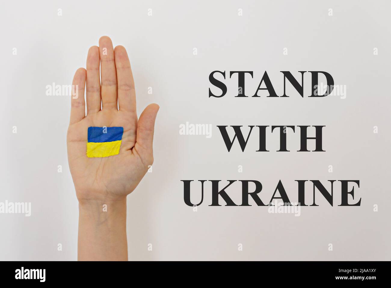 Close up shot of a female's palm of hand with Ukrainian national flag ...