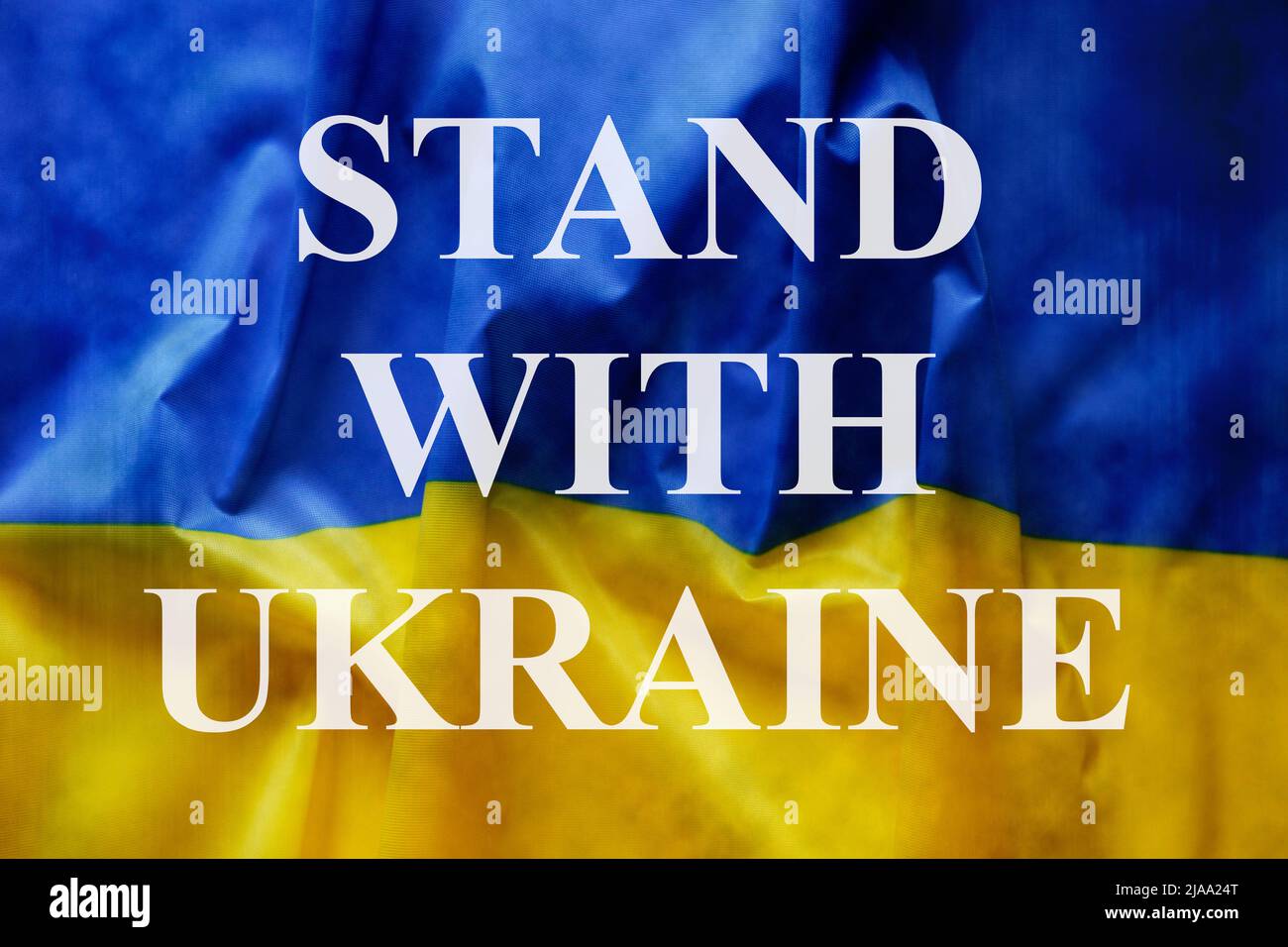 Stand with Ukraine slogan written over ruffled Ukrainian yellow and ...